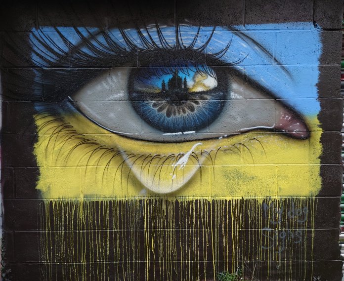 Beautiful artwork of a crying eye featuring Ukraine’s flag and bombing ...