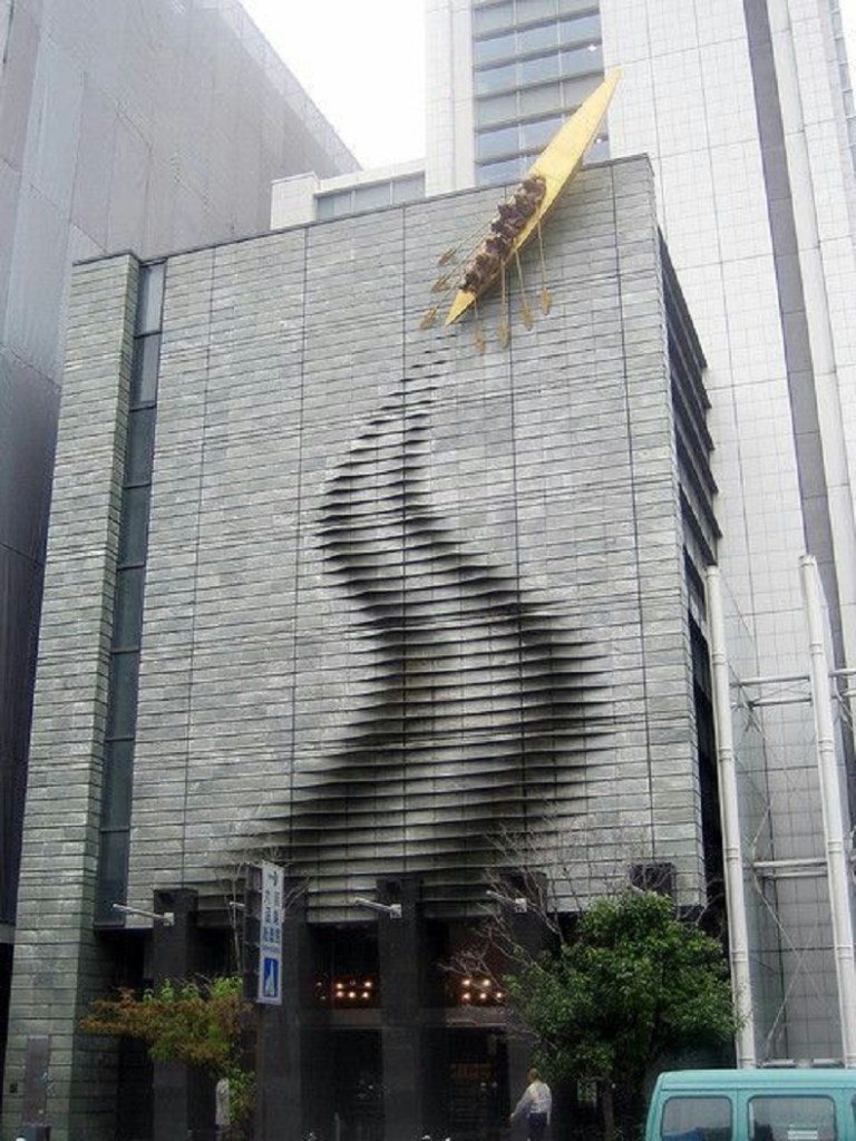 Sculpture of a canoe climbing a high-rise building in Osaka, Japan ...